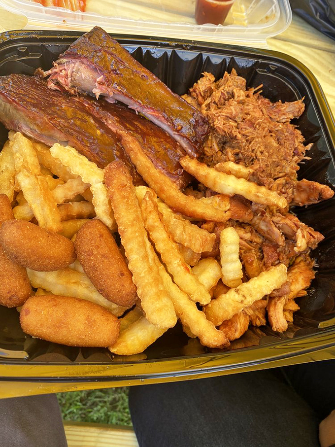 The holy trinity of barbecue &ndash; ribs, pulled pork, and those golden fries. This tray should come with a warning: "May induce immediate happiness."