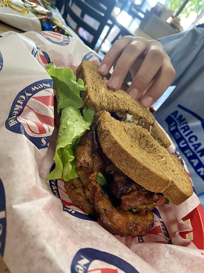 Someone's about to experience sandwich bliss. That toasted rye, crisp lettuce, and what appears to be bacon that's achieved golden-brown perfection.