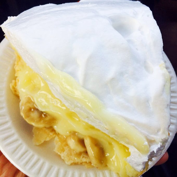 The banana cream pie stands tall and proud, with meringue peaks that would make the Himalayas jealous.