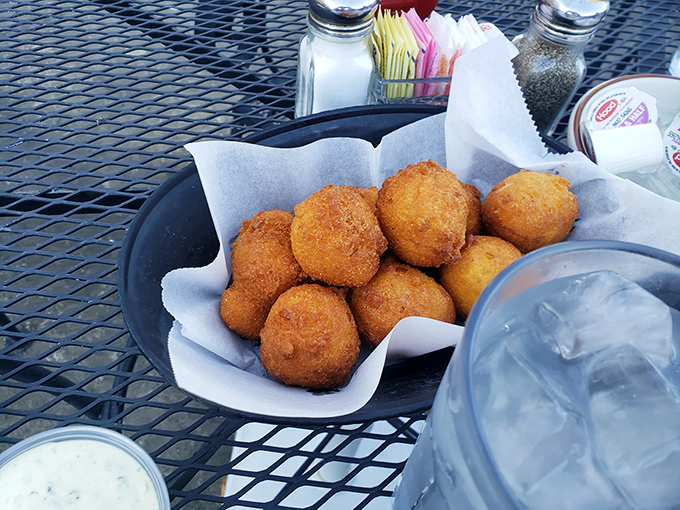 A basket of hush puppies that demands to be photographed before being devoured. Like tiny edible meteors that crashed into a sea of deliciousness.