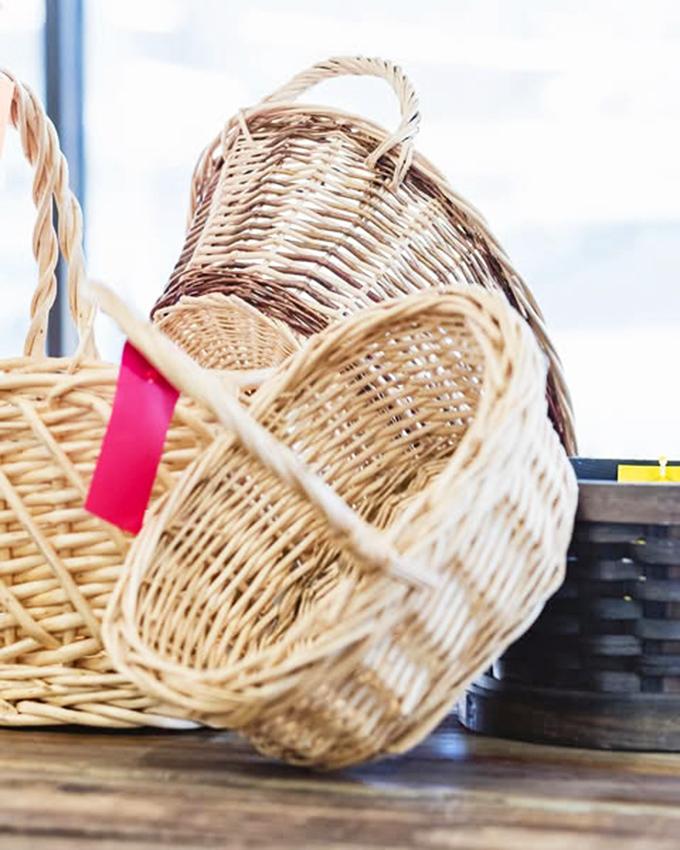 Wicker baskets with red price tags&mdash;practical art that's survived decades. Martha Stewart would pay triple for these "authentic" pieces at a fancy home store.