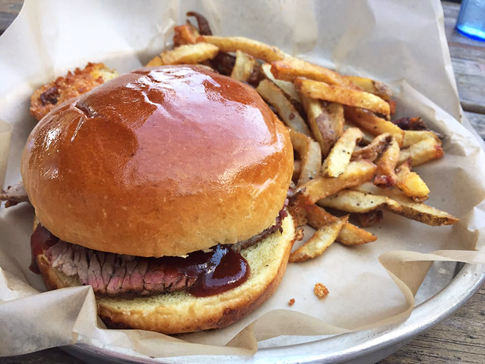 This isn't just a sandwich; it's a commitment. The glossy bun and tender brisket create a partnership more harmonious than Simon and Garfunkel.