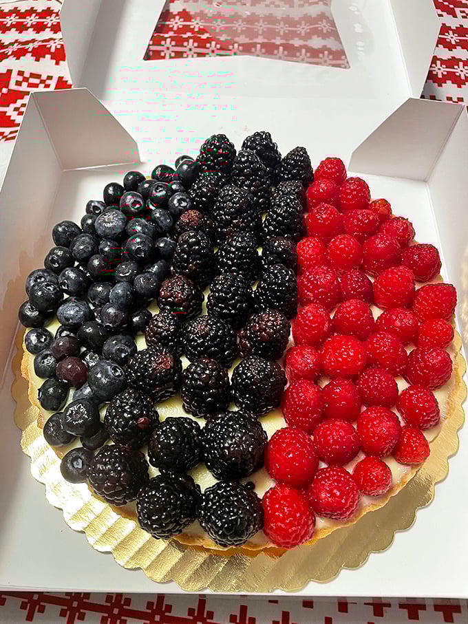 Nature's candy arranged with artistic precision&mdash;blueberries, blackberries, and raspberries nestled on a canvas of custard. Picasso would eat his heart out.