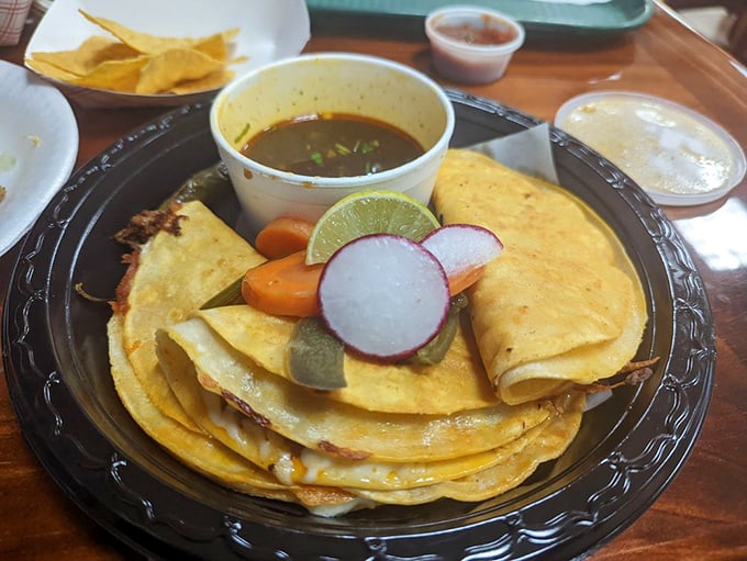 Quesadillas that achieve the golden ratio of crispy exterior to molten interior, with garnishes that add both color and crucial flavor contrast.