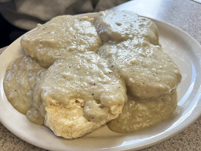 Biscuits and gravy that look like they were conceived during a particularly ambitious dream &ndash; comfort food that laughs in the face of moderation.