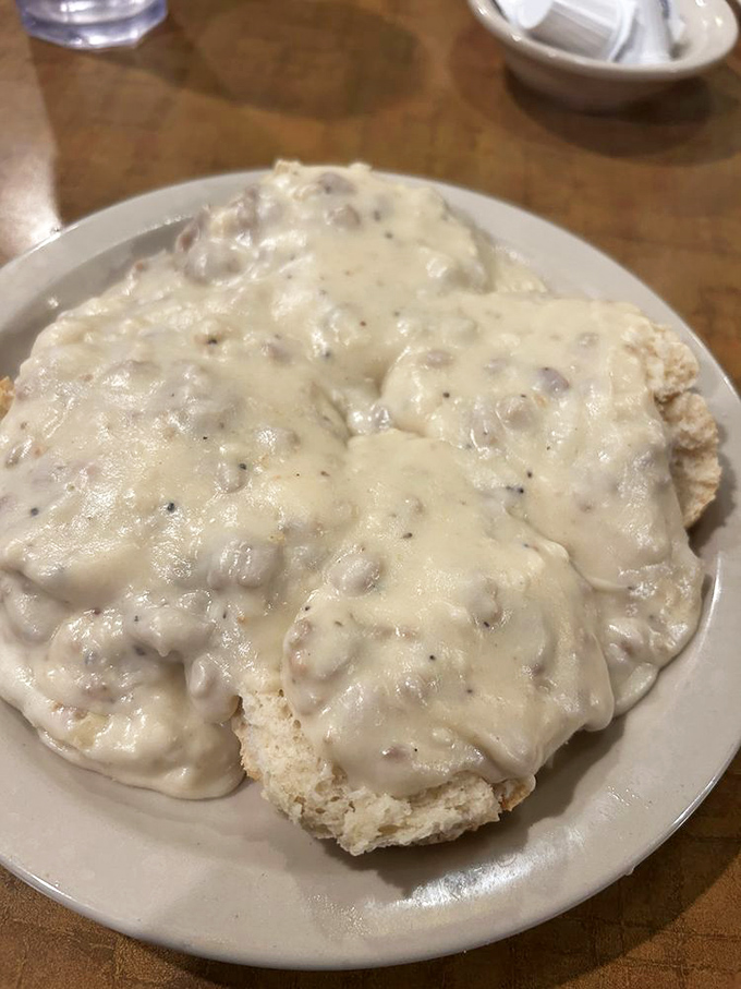 Biscuits and gravy - the breakfast that says "Your diet starts tomorrow." This plate contains more comfort than three seasons of Ted Lasso.