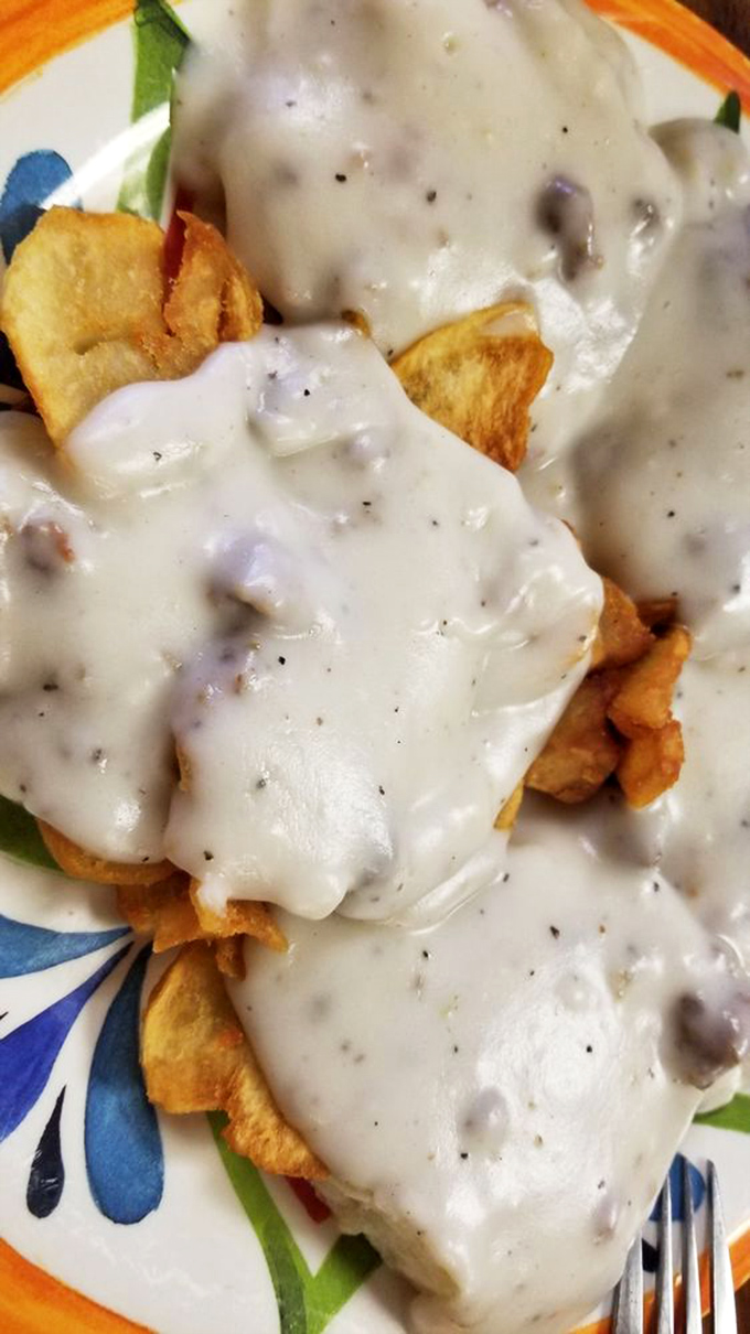 Biscuits and gravy so good they should require a permission slip. That sausage gravy blanket is tucking those home fries in for the nap you'll want after.