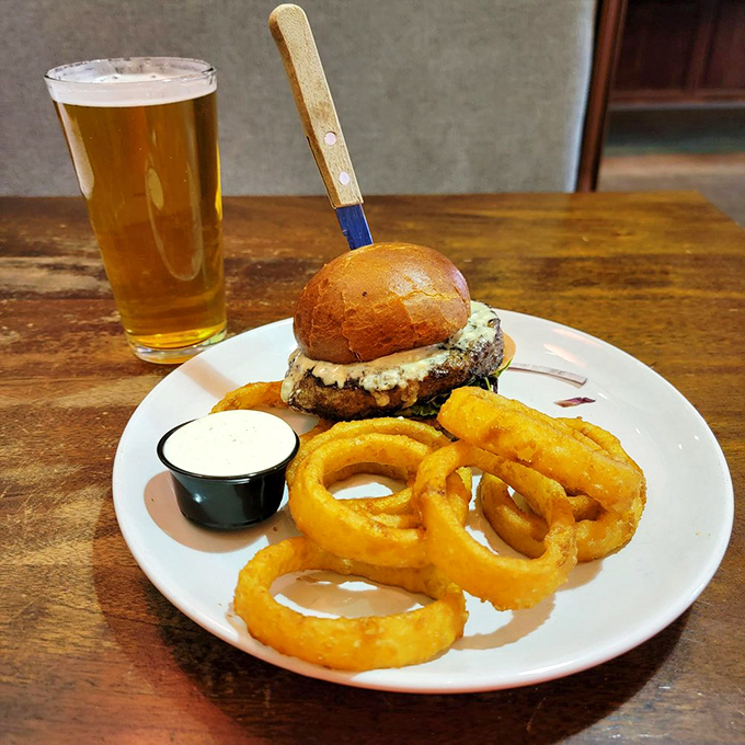 The Black and Blue burger arrives like a work of art&mdash;blue cheese melting over beef, with onion rings that crunch loud enough to turn heads.