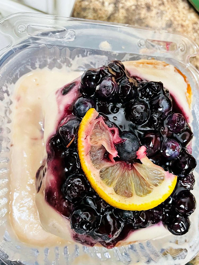 Blueberries and lemon slice nestled in creamy goodness&mdash;nature and indulgence having a little summit meeting in your dessert cup.