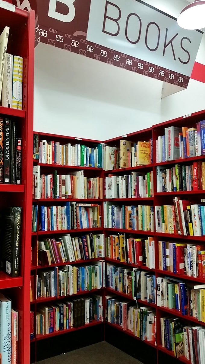 The book corner offers literary treasures organized in Arc's signature red shelving—a bibliophile's dream where every spine tells two stories.
