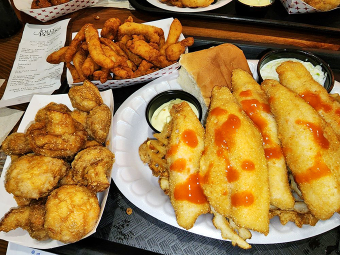 A seafood feast fit for Neptune himself. Those clam strips with their hot sauce drizzle are the rockstars of this paper plate concert.