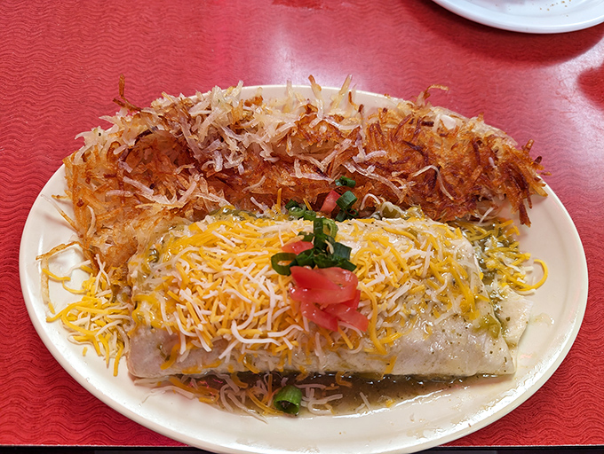 Breakfast burrito royalty: Cheese melting into submission, crispy hash browns standing guard, and a tortilla holding everything in one perfect package.
