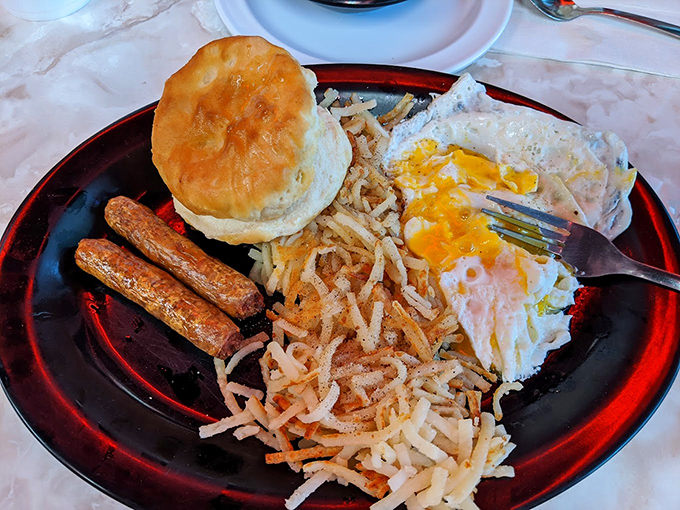 Breakfast diplomacy: when eggs, hash browns, sausage and a biscuit negotiate perfect harmony on a plate.