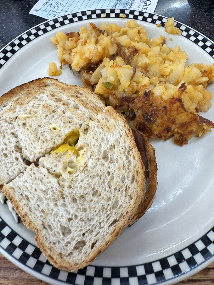 Breakfast sandwich perfection isn't complicated: golden toast, farm-fresh eggs, and home fries with the ideal crisp-to-fluffy ratio that scientists should study.