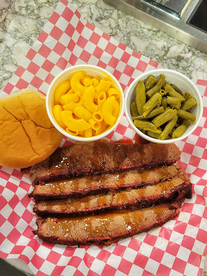 The holy trinity of Southern comfort: perfectly sliced brisket, mac and cheese that glows like a sunset, and green beans that actually taste good.