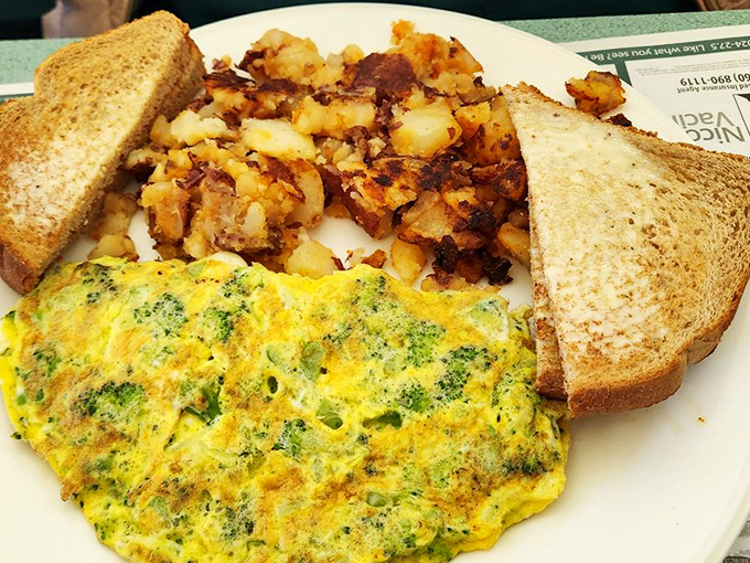 The broccoli omelet—where vegetables become breakfast heroes. Paired with those home fries, it's the breakfast equivalent of Batman and Robin.