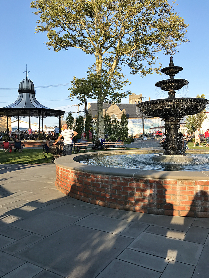 The town square where locals gather, tourists rest their shopping-weary legs, and that fountain has heard more secrets than a hairdresser on Saturday.