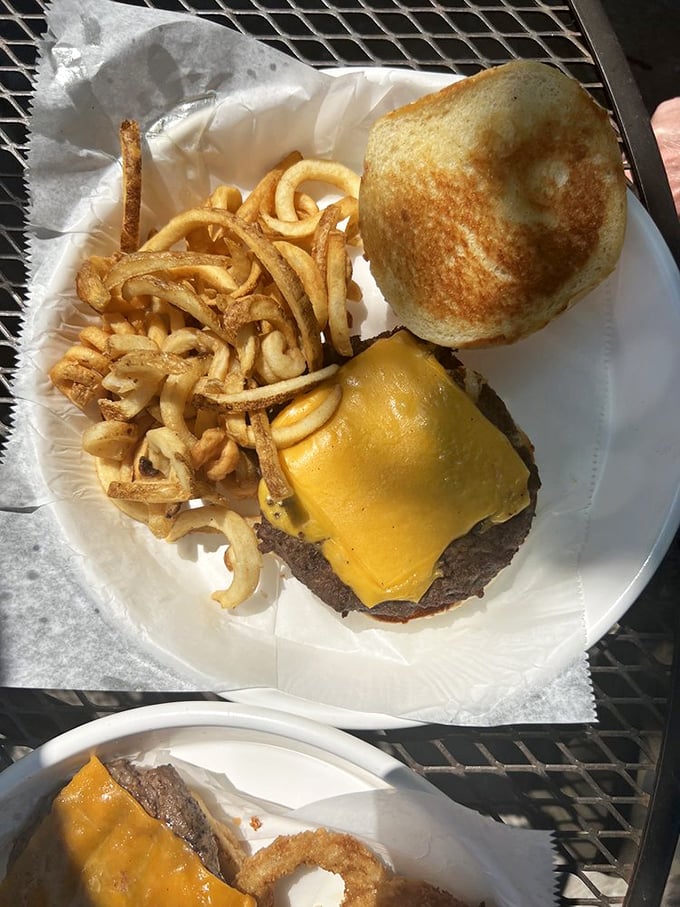 Sometimes the simplest pleasures are the most profound: hand-cut fries and a cheese-draped burger on a toasty bun.