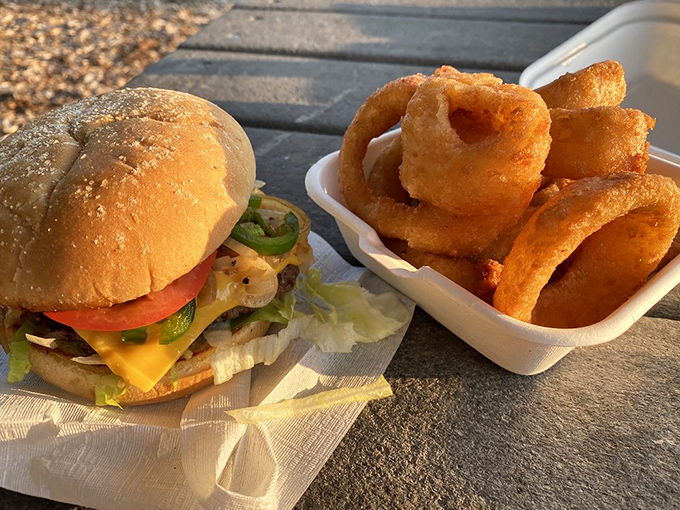 Burger on the left, golden onion rings on the right&mdash;a relationship more harmonious than most marriages I know.