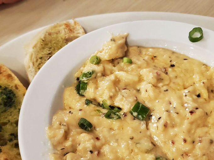 This creamy, cheesy crab dip arrives with garlic bread for dipping—a combination so perfect it should have its own romantic comedy soundtrack.