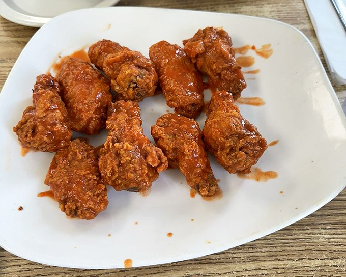 These aren't just wings; they're little crispy messengers of joy. The sauce-to-meat ratio? Perfection on a plate. 
