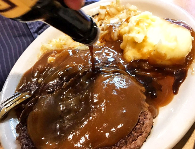 Behold the gravy waterfall! This hamburger steak and mashed potatoes combo is what comfort food dreams are made of.