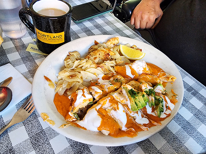 Chilaquiles that would make your abuela proud&mdash;a vibrant plate where spicy sauce meets cool cream, with avocado slices providing moments of buttery calm.
