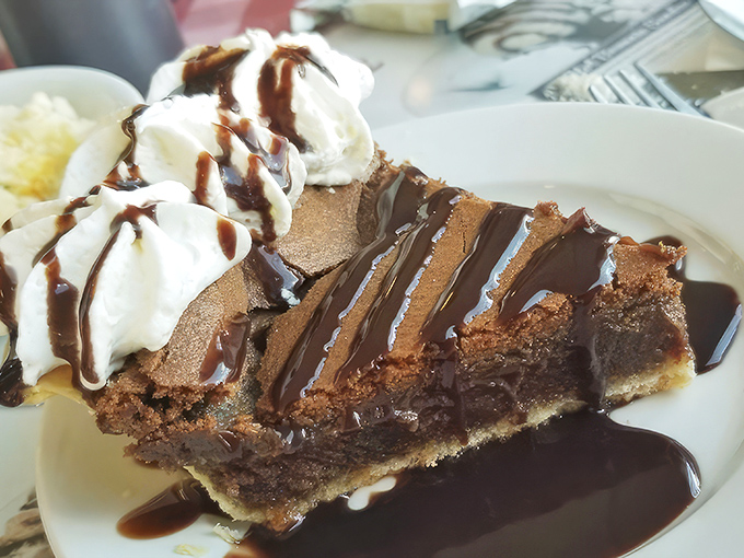 Chocolate chess pie drizzled with sauce and topped with whipped cream&mdash;because sometimes dessert should look like it's dressed for the prom.