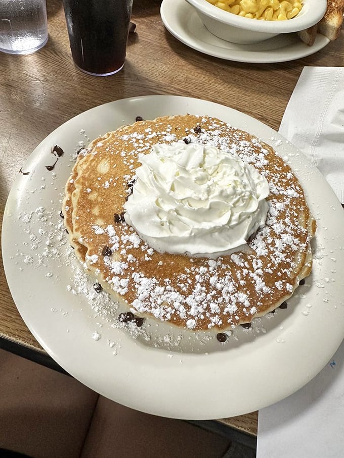 Chocolate chip pancakes dusted with powdered sugar and crowned with whipped cream&mdash;proof that sometimes the best desserts masquerade as breakfast.