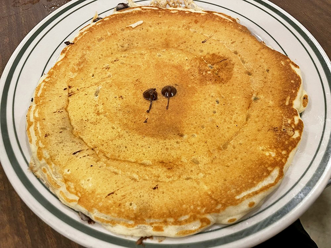 The chocolate chip pancake &ndash; childhood joy in adult-sized portions. Those melty chocolate spots are like treasure maps to happiness on your plate.
