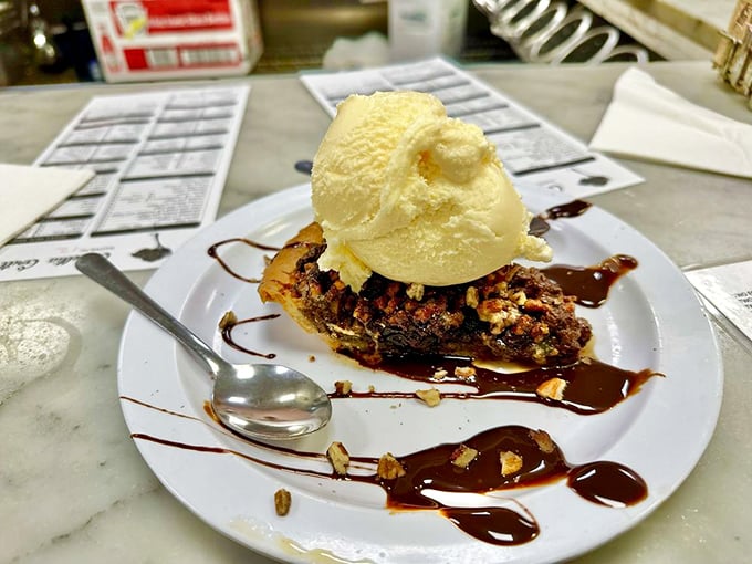 Pecan pie gets the royal treatment with a scoop of vanilla ice cream creating that magical moment when hot meets cold in dessert paradise.