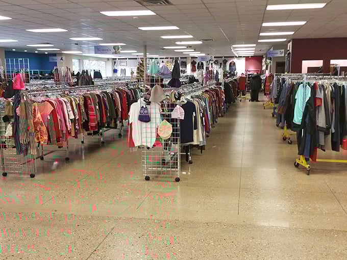 Clothing racks stretch like colorful rivers across the floor, carrying everything from everyday basics to occasional designer gems hiding in plain sight.