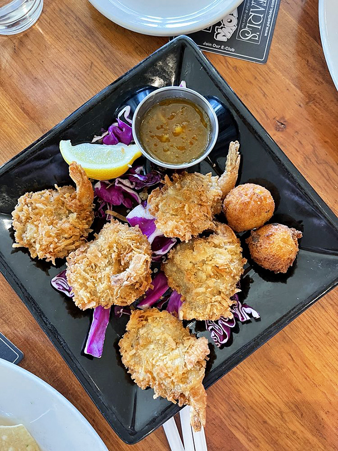 Golden coconut shrimp that crunch like your favorite childhood memory, served with a dipping sauce worth bottling and taking home.