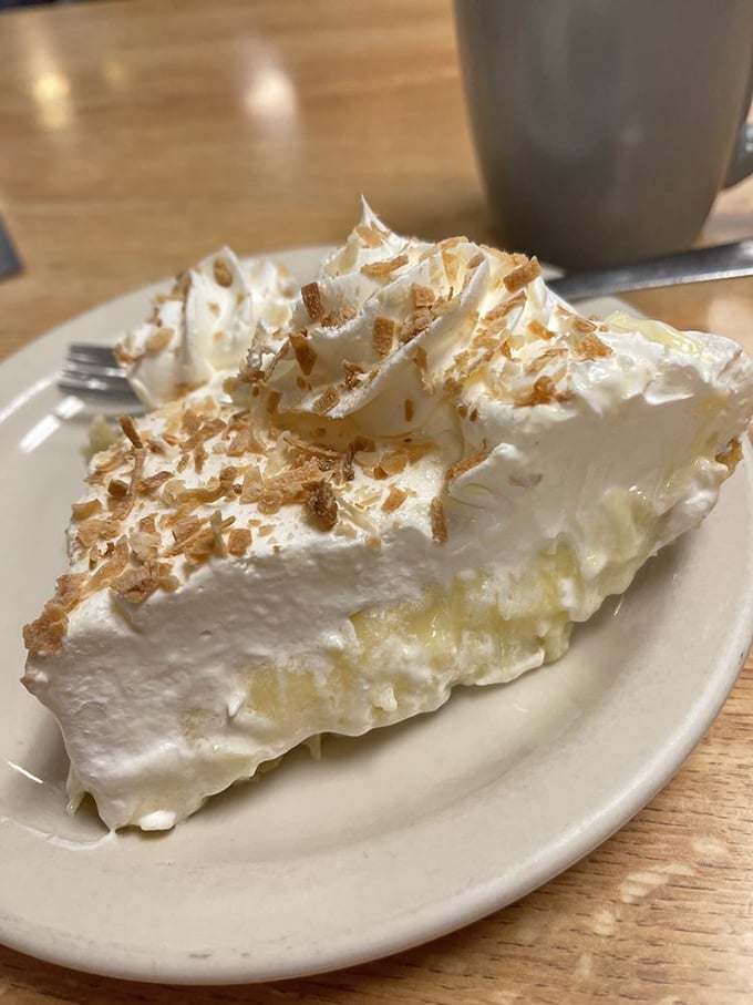 Coconut cream pie that would make Tom Hanks' Castaway character weep with joy. That toasted coconut sprinkle isn't decoration - it's a flavor exclamation point!