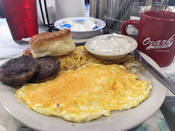 Morning glory on a plate: a cheese omelet that's seen the sun, perfectly crisped hash browns, and a biscuit that could make a Southern grandmother weep with pride.