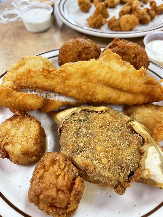The seafood platter that launched a thousand return visits – a cornmeal-crusted wonderland where the fish is so fresh, you'll forget you're a thousand miles from any ocean.