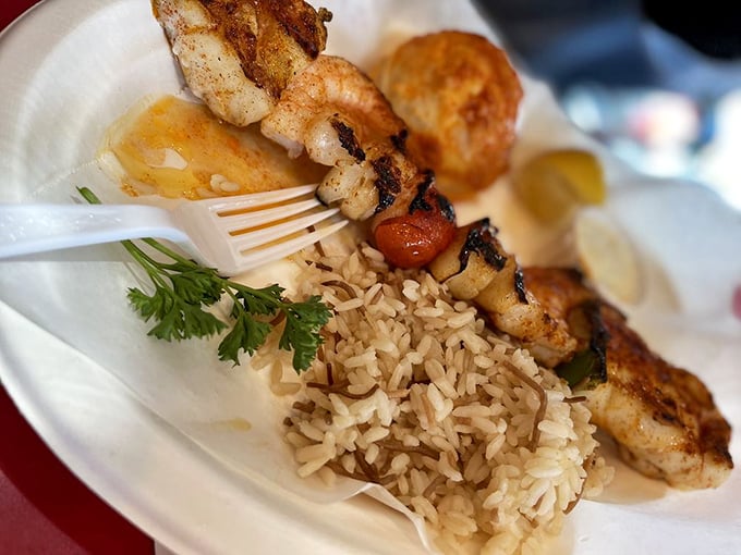 Skewered shrimp and perfectly grilled seafood alongside rice pilaf. Proof that the best things in life come on sticks.