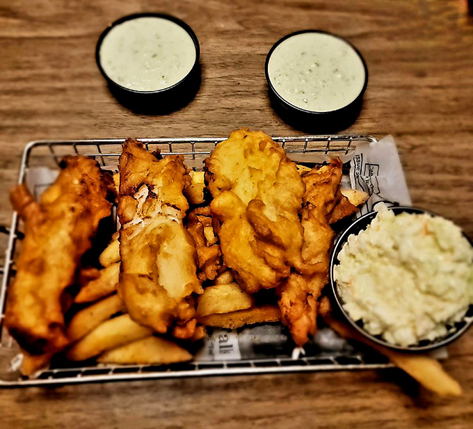 Behold the fish and chips that launched a thousand return trips. The coleslaw adds a fresh crunch that cuts through the richness like a lighthouse beam through fog.