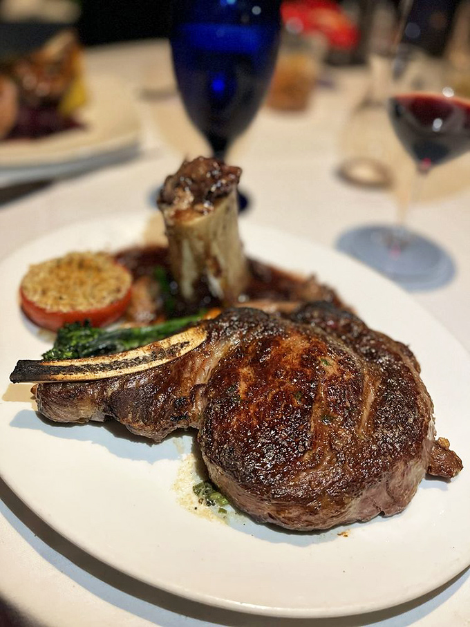 The bone-in ribeye arrives like a prehistoric trophy of deliciousness. That sear isn't just a cooking technique; it's a philosophy about living life to its fullest potential.