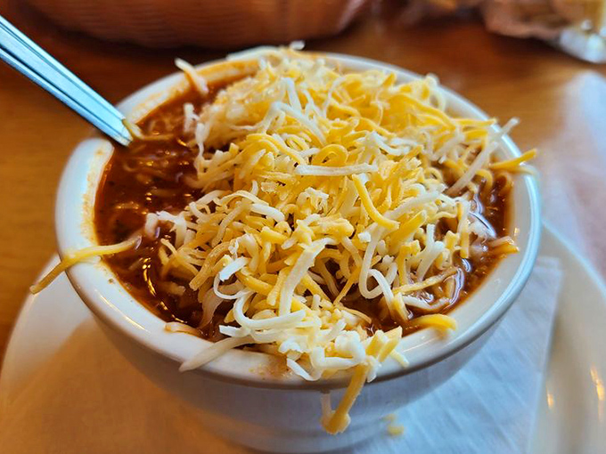 A hearty bowl of chili topped with melted cheese&mdash;because even at a fish house, sometimes you need something that sticks to your ribs like a good story.
