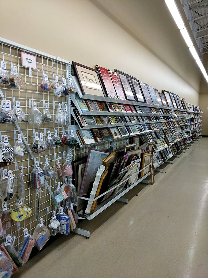 Wall art waiting for its second act&mdash;one person's donated wedding portrait becomes another's ironic office decoration or genuine treasure.