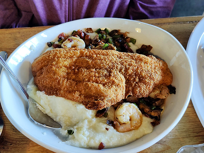 Comfort food perfection: golden-fried chicken atop creamy grits with shrimp and bacon. Your diet can wait until tomorrow.