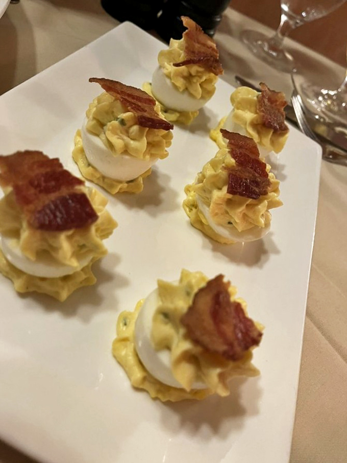 Deviled eggs reimagined as elegant appetizers. These bite-sized beauties topped with bacon would make your grandmother both confused and proud.