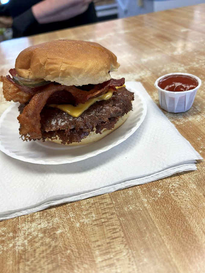 Bacon makes everything better, especially when it's crowning a crispy-edged smash burger with melted cheese at Carl's Drive-In.