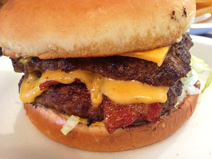This isn't just a burger&mdash;it's a skyscraper of satisfaction with melty cheese cascading down like delicious lava. Napkins required, regrets impossible.