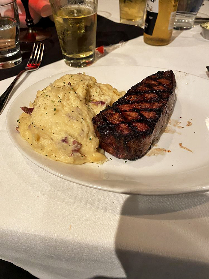 Meat candy for grown-ups. The dry-aged New York Strip arrives with perfect cross-hatched grill marks and a side of happiness.