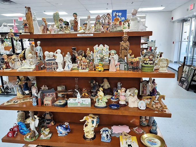 The figurine section&mdash;where porcelain angels, ceramic children, and decorative knickknacks form a miniature society frozen in perpetual politeness. 