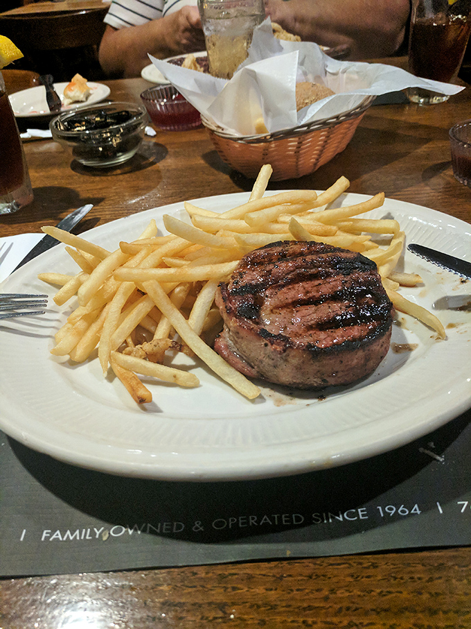 This filet mignon isn't just a steak&mdash;it's a perfectly circular testament to bovine excellence, flanked by golden fries standing at attention.