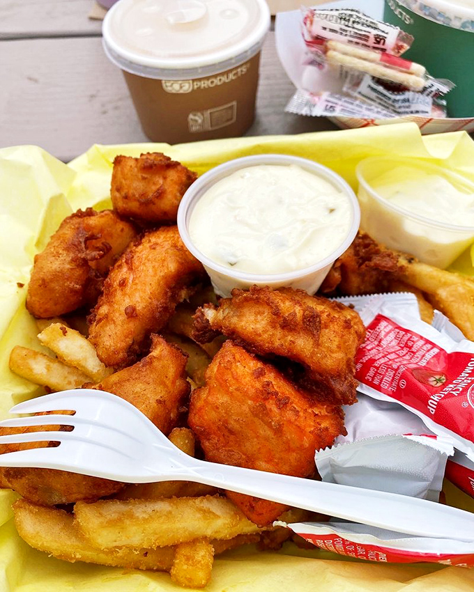 Fried seafood paradise on yellow paper&mdash;where calories don't count and happiness comes battered. The tartar sauce is just a bonus.