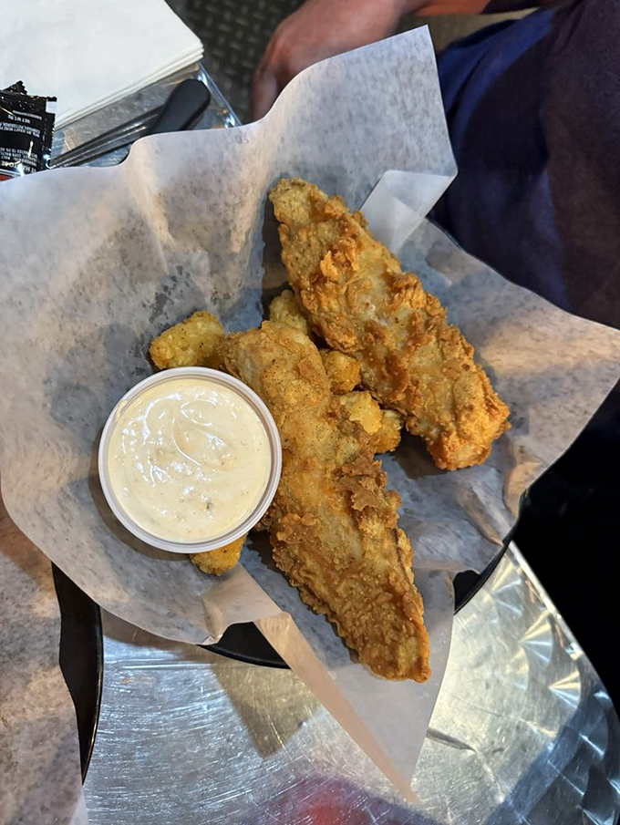 Golden-battered fish tenders that crunch like autumn leaves, paired with a dipping sauce worthy of its own fan club.